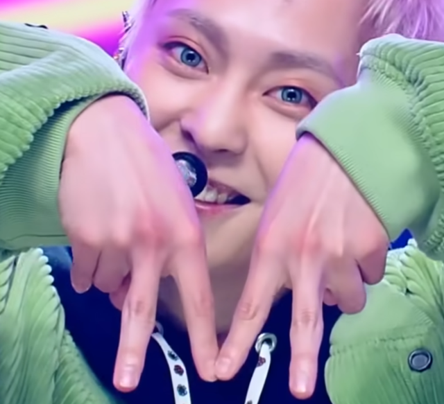 can i ask here what does the hand sign means? it is from xiumin's brand ...