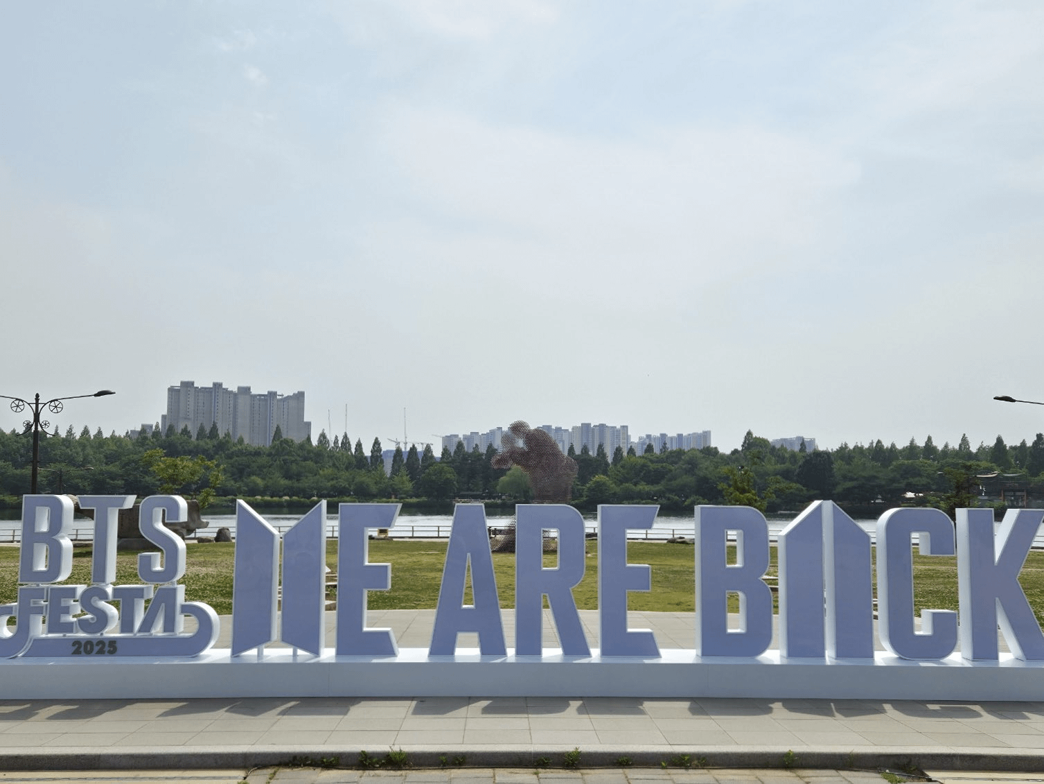 A "BTS FESTA 2025 WE ARE BACK" sign has been put up near KINTEX Hall ...
